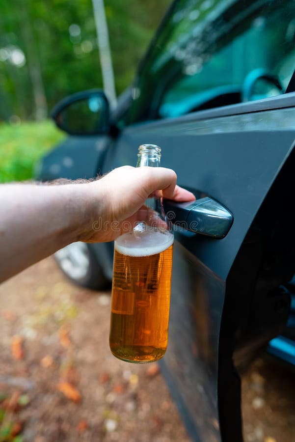 Man with a Bottle of Beer Gets into a Car. Stock Image - Image of hand ...