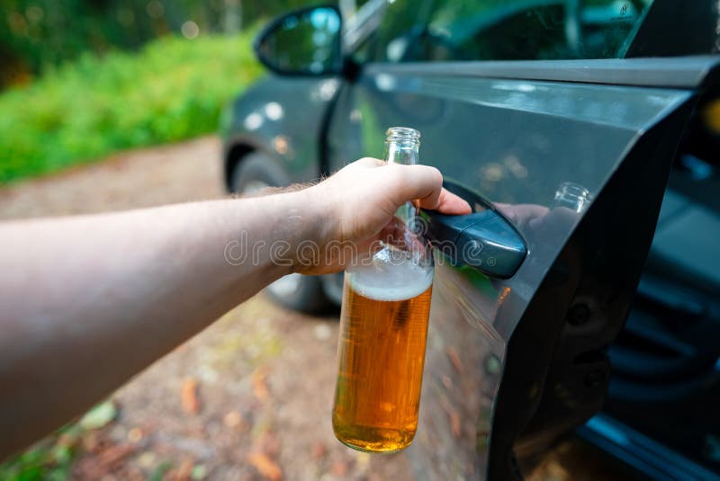 Man with a Bottle of Beer Gets into a Car. Stock Photo - Image of drunk ...