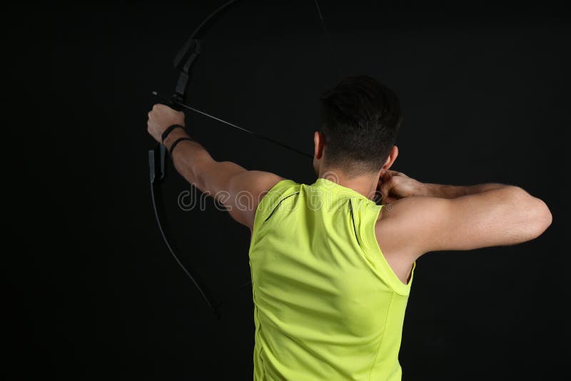 Man with Bow and Arrow Practicing Archery on Black, Back View Stock ...