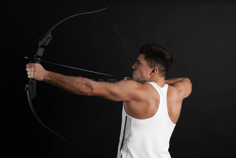 Man with Bow and Arrow Practicing Archery on Black Background Stock ...