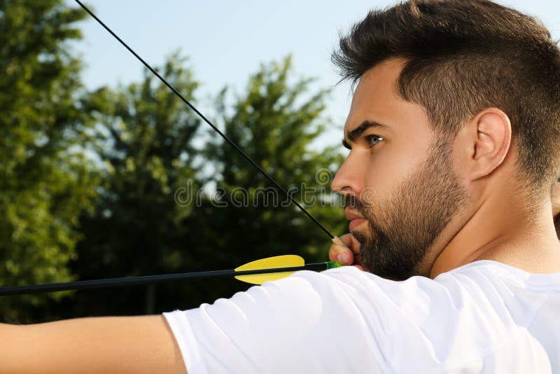 Man with Bow and Arrow Practicing Archery in Park, Closeup Stock Image ...