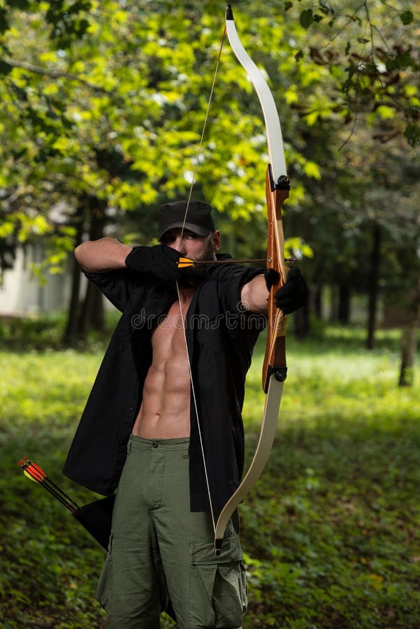 Man with a Bow and Arrows in Woods Stock Image - Image of handsome ...