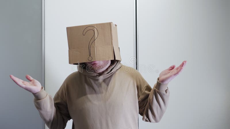 A Man with a Box on His Head with a Question Mark, Showing that he Does ...