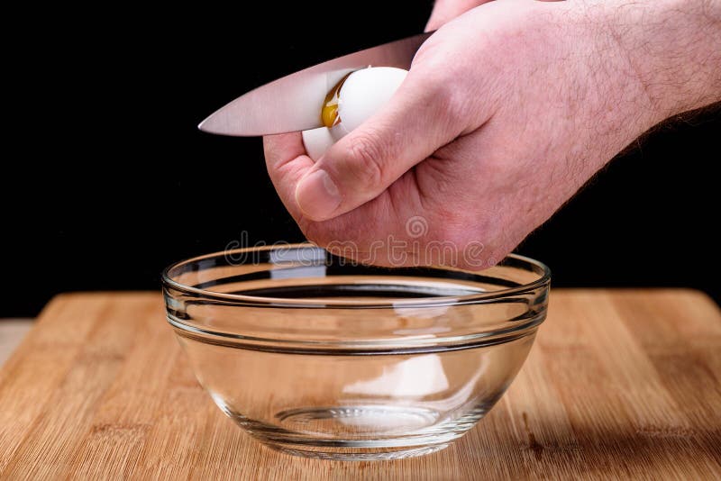 A Man is Breaking an Egg. Yolk from a Broken Shell. Stock Photo - Image ...