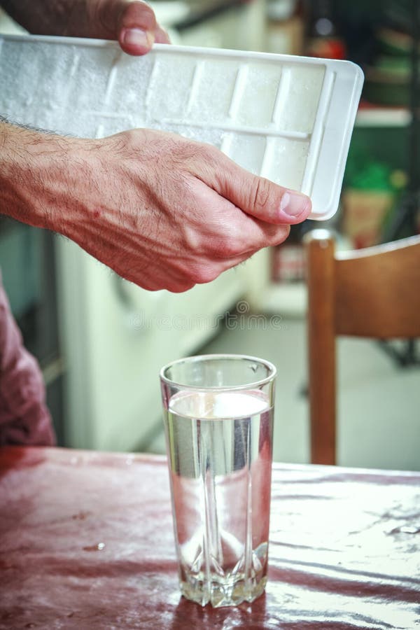 Man Breaking the Ice, Cooling Water in a Glass Stock Photo - Image of ...