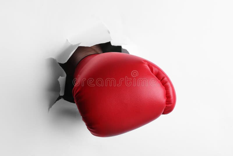 Man Breaking through White Paper with Boxing Glove, Closeup Stock Photo ...