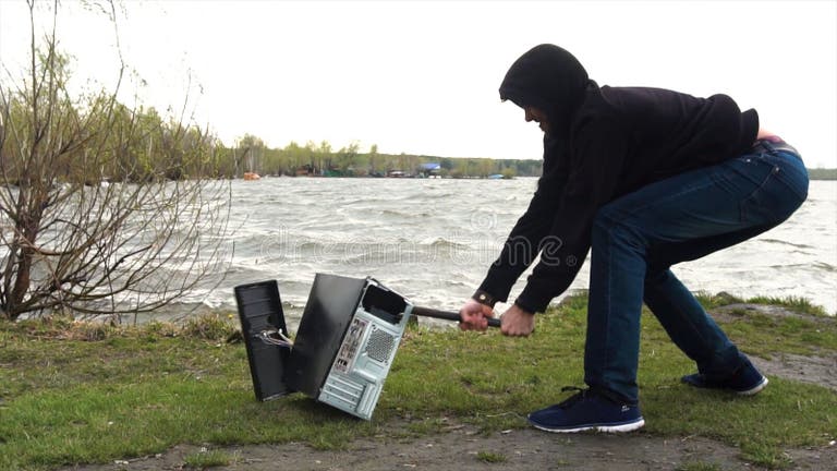 Man Breaks a Hammer System Unit Computer. Man with a Sledge Hammer and ...