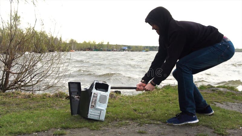 Man Breaks a Hammer System Unit Computer. Man with a Sledge Hammer and ...