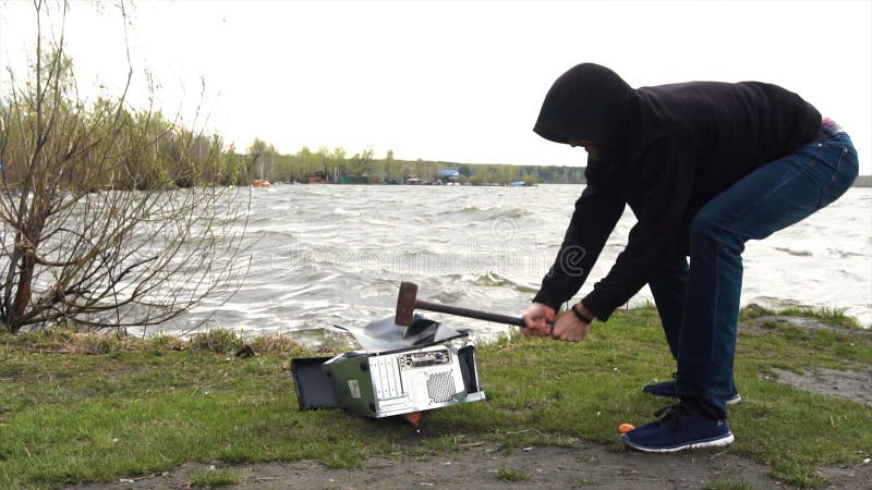 Man Breaks a Hammer System Unit Computer. Man with a Sledge Hammer and ...