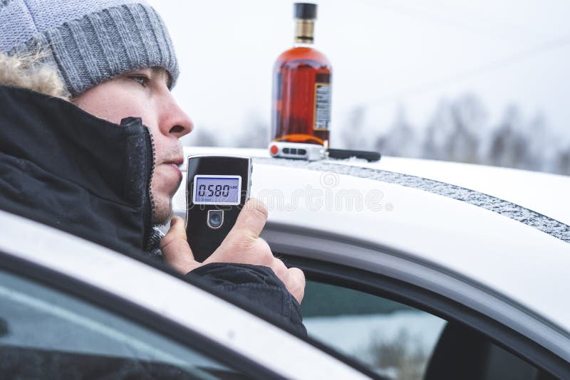 A Man with a Breathalyzer in the Car Stock Photo - Image of insurance ...