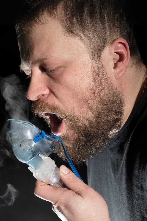 Man Breathing through Nebulizer Mask Stock Photo - Image of medicine ...
