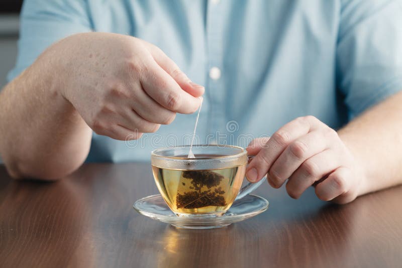 Man Brewing Tea Bag with Glass of Tea on Table Stock Photo - Image of ...