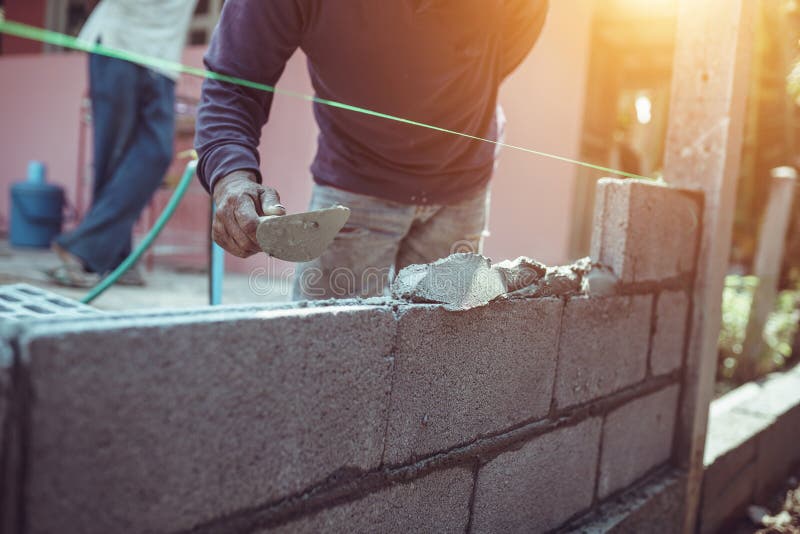 Man Bricklayer Building a Brick Wall or Wall Construction Stock Image ...