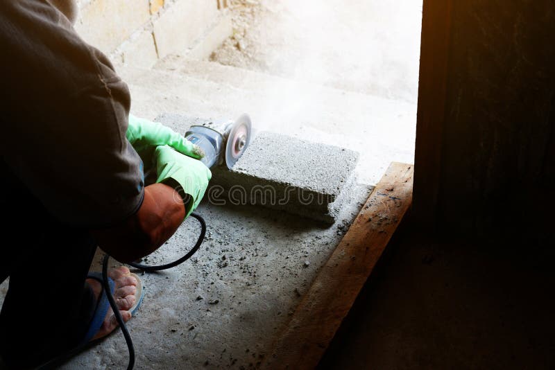 Man Bricklayer is Cutting Cement Brick Block with Small Cutter Machine ...
