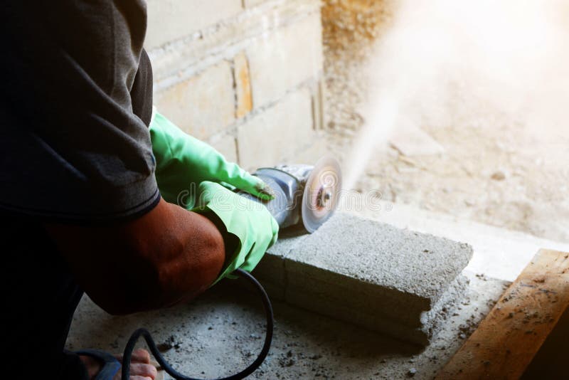 Man Bricklayer is Cutting Cement Brick Block with Small Cutter Machine ...