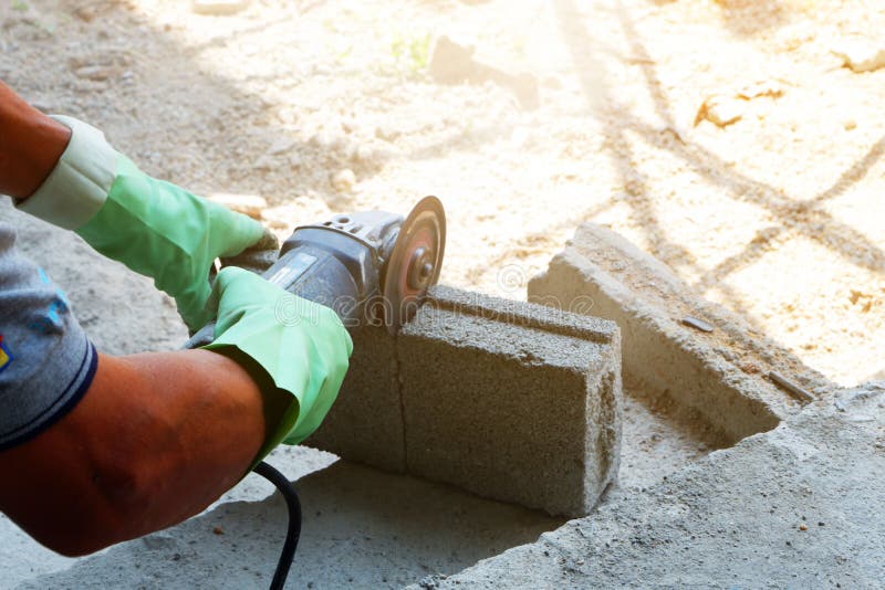 Man Bricklayer is Cutting Cement Brick Block with Small Cutter Machine ...