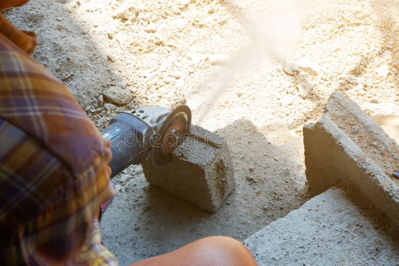 Man Bricklayer is Cutting Cement Brick Block with Small Cutter Machine ...