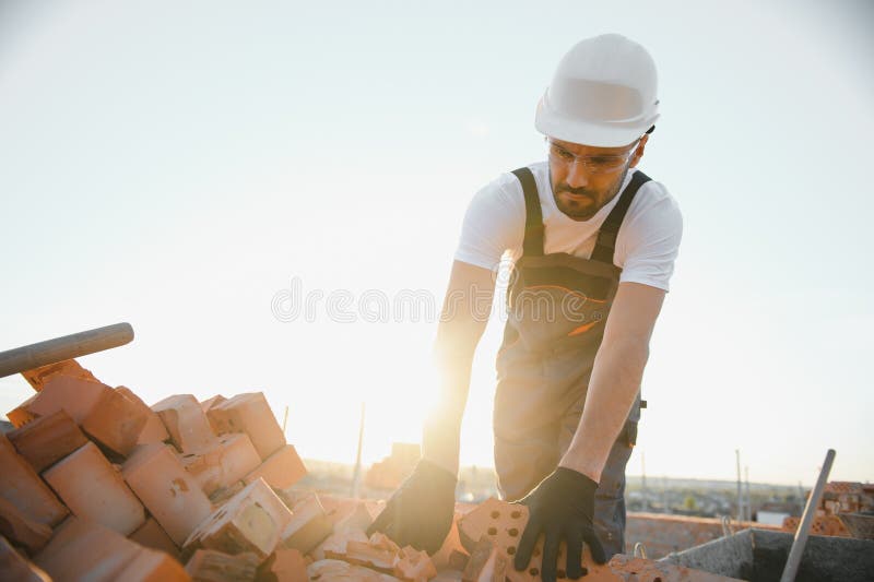 Man Bricklayer Installing Bricks on Construction Site Stock Photo ...
