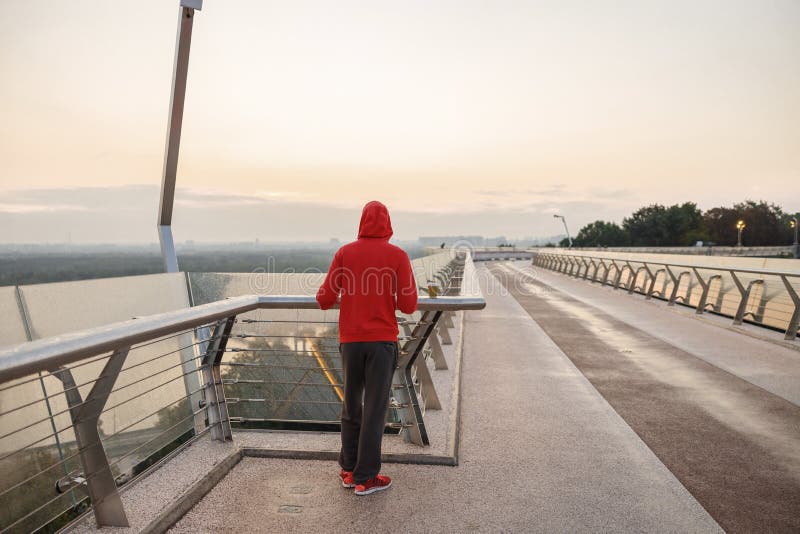 Man on a Bridge Looking into the Distance Stock Photo - Image of ...