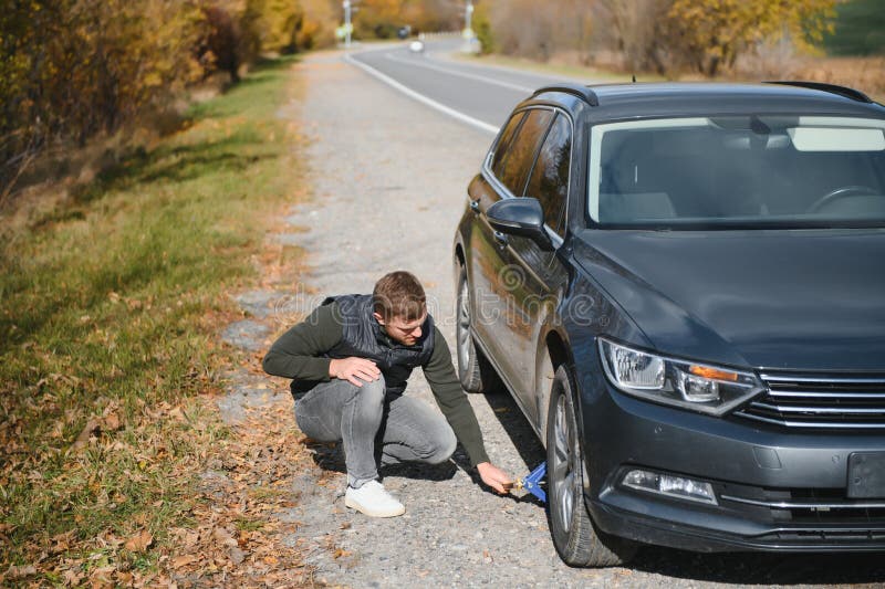 Man with Broken Down Car Flat Tire in the Middle of the Street Stock Image - Image of auto ...