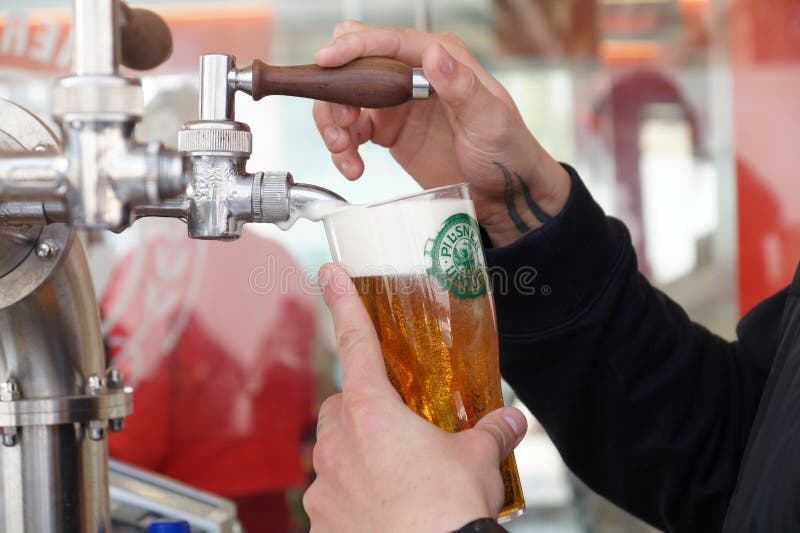 Man Brooch Draft Beer during Demonstration. is an Alcoholic Beverage ...