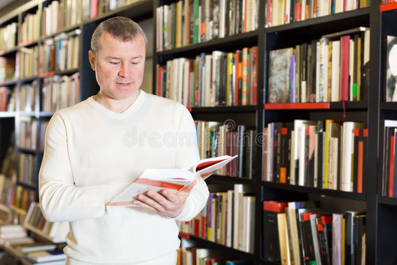 Man Browsing Inside of Books while Visiting Library Stock Photo - Image ...
