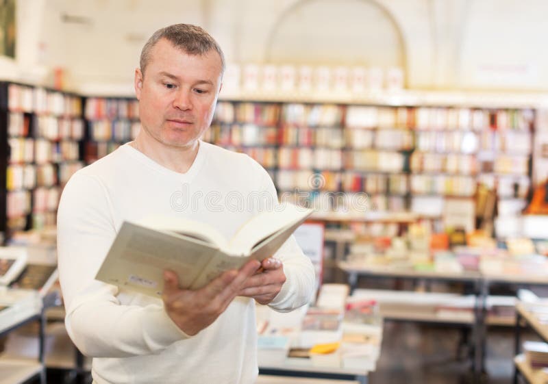 Man Browsing Inside of Books while Visiting Library Stock Image - Image ...