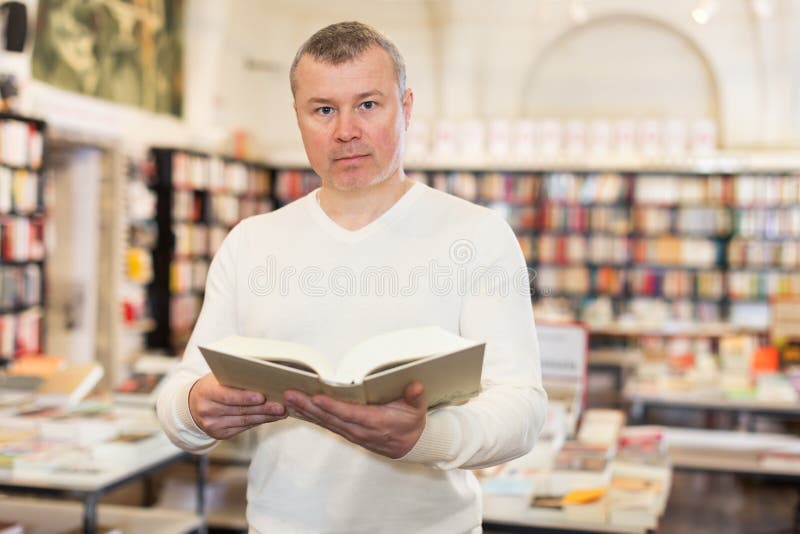 Man Browsing Inside of Books while Visiting Library Stock Photo - Image ...