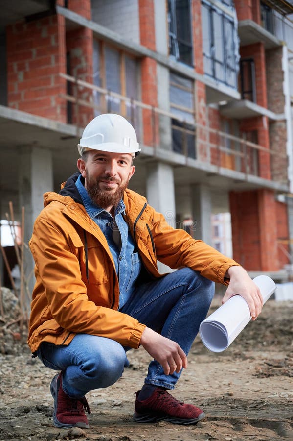 Man Builder Crouching Down Outdoors at Construction Site. Stock Image ...