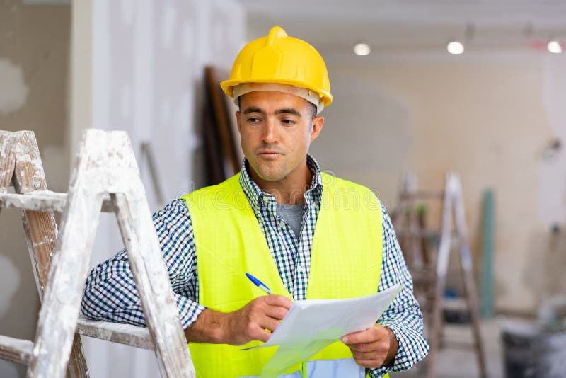 Man Builder Examining Project Documentation in Apartment Stock Image ...