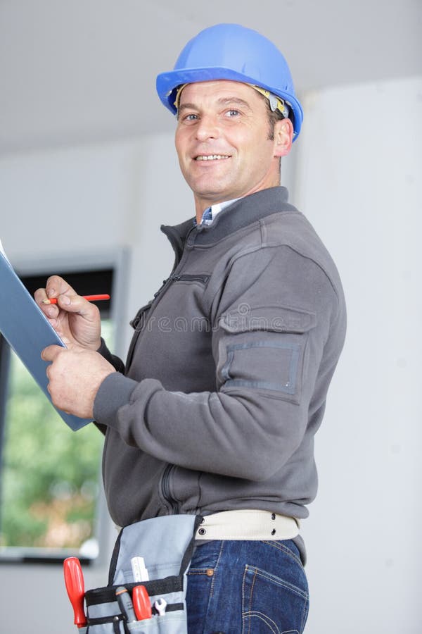 Man Builder in Hard Hat Writing on Clipboard Stock Image - Image of ...