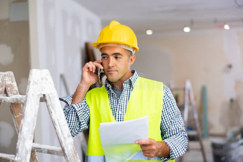 Man Builder Having Telephone Conversation in Construction Site Stock ...
