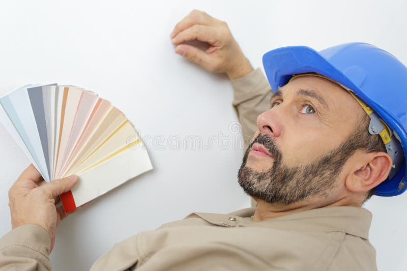 Man Builder Holding Color Swatch and Thinking Stock Image - Image of ...