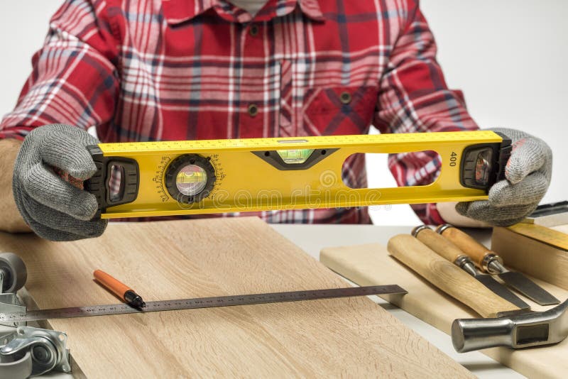 Man Builder with Level and Working Tools on Table. Measure Concept ...