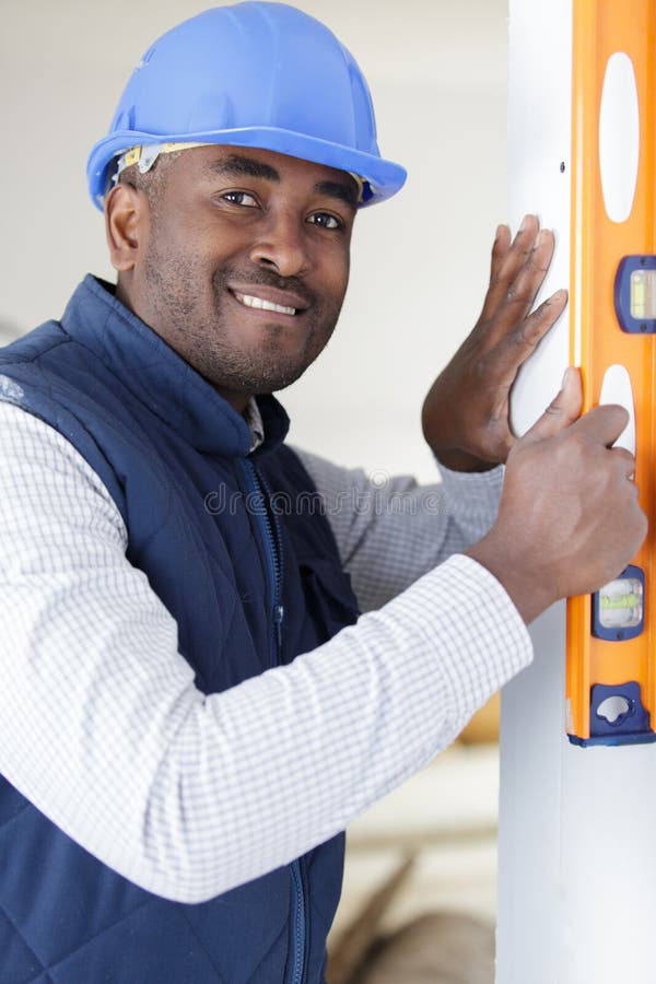 Happy Builder Measuring Wall Stock Image - Image of helmet, occupation ...