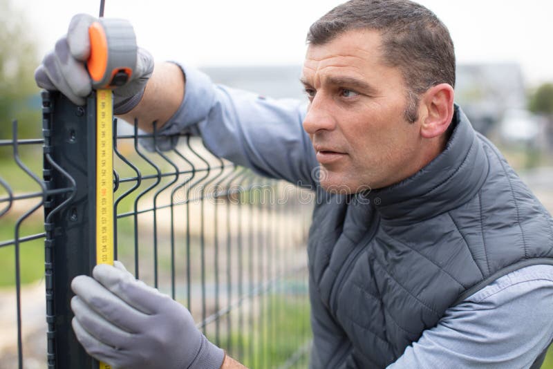 Man Builder Making Fence Using Tape Measurer Stock Image - Image of ...