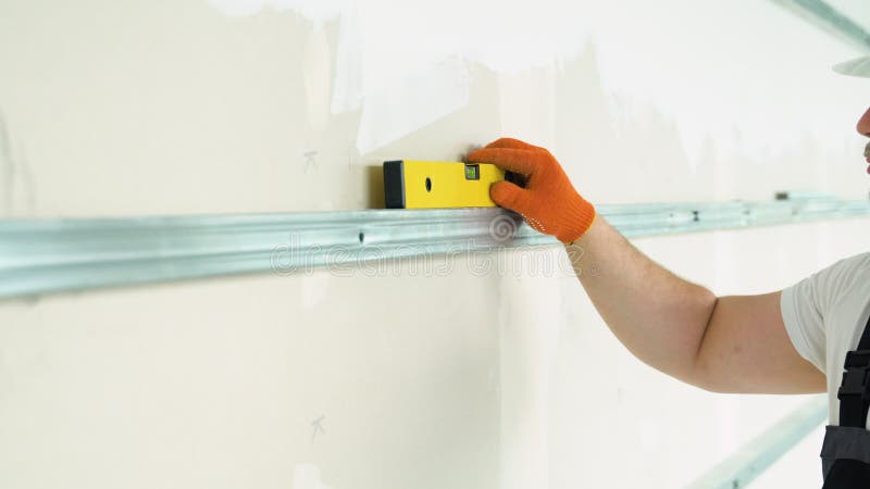 A Man Builder Measures of the Horizontal Deviation of Plasterboard Wall ...