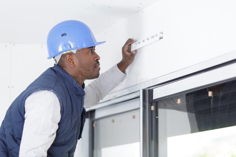 Man builder measures wall stock image. Image of adult - 264498337