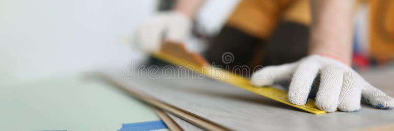 Man Builder Measuring Laminate Board with Ruler for Laying Floor ...