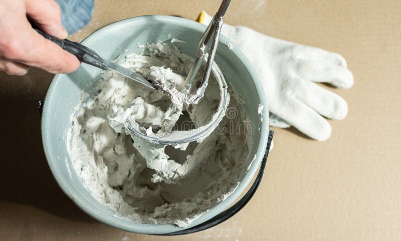Builder with a Putty Knife, Apply the Putty To the Wall. Repair the ...