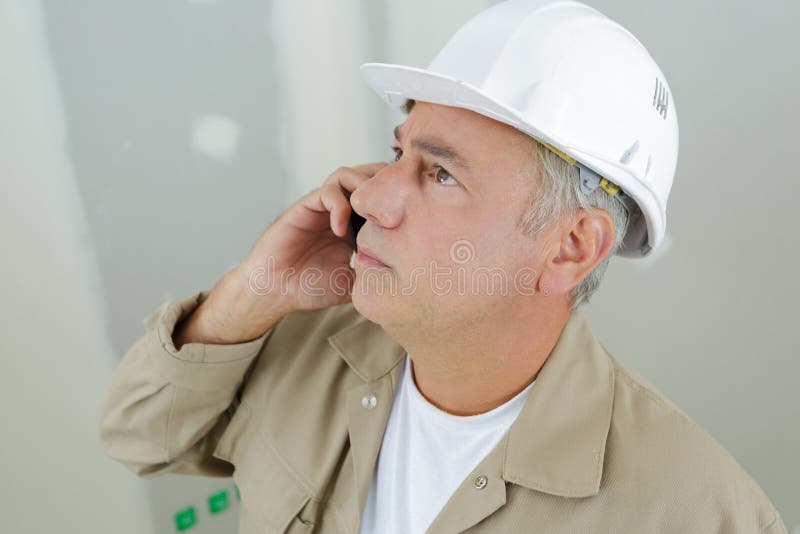 Man builder on phone stock image. Image of construction - 237592333