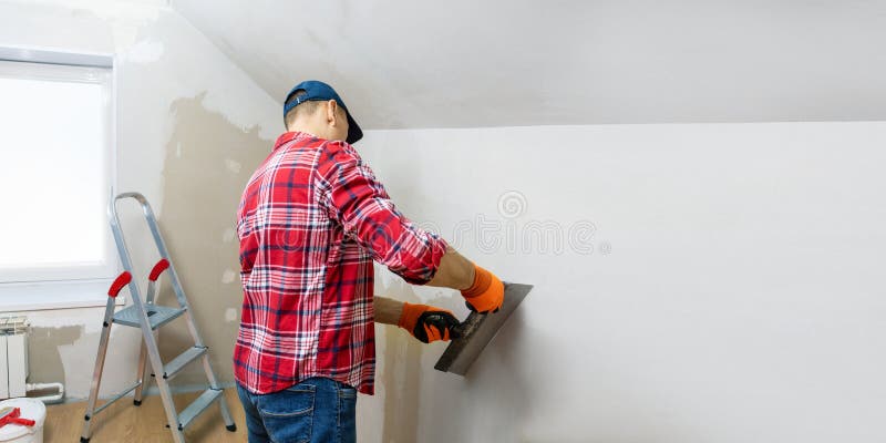 Man Builder Plastering a Wall Using a Construction Trowel. House ...