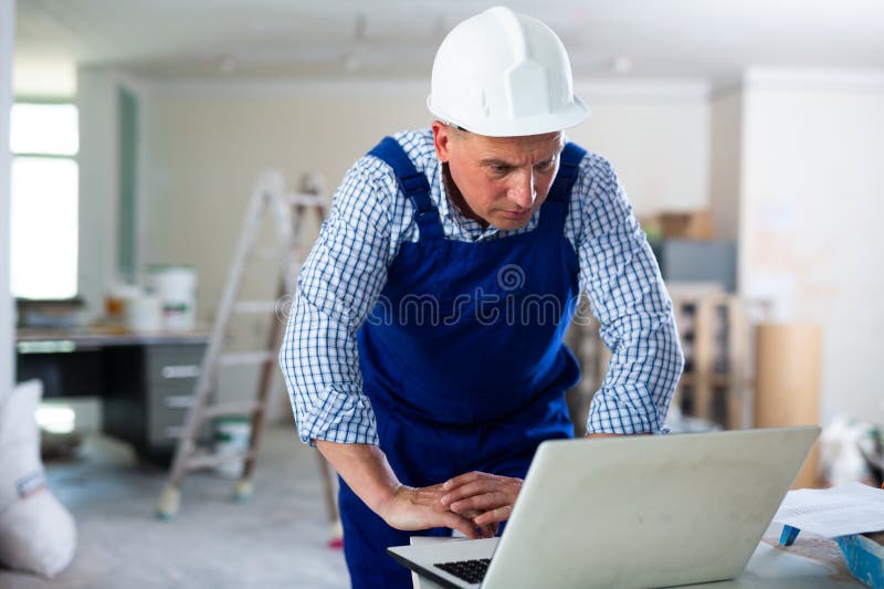 Man Builder Using Laptop in Construction Site Stock Image - Image of ...