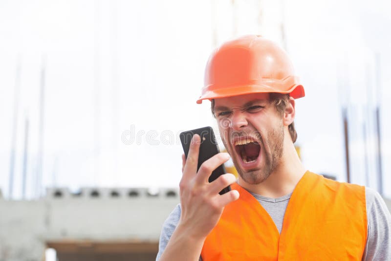 Man Builder Worker in Helmet Screaming in Mobile Phone on Construction ...