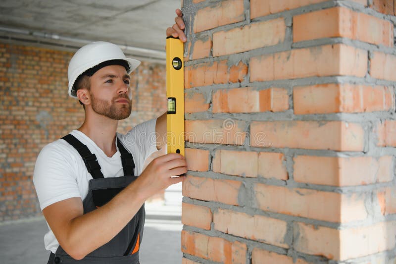 Man Builder Working in Construction Site. Male Repairer in Overall and ...