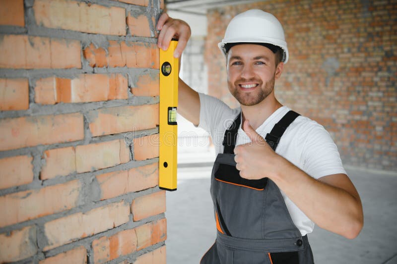 Man Builder Working in Construction Site. Male Repairer in Overall and ...