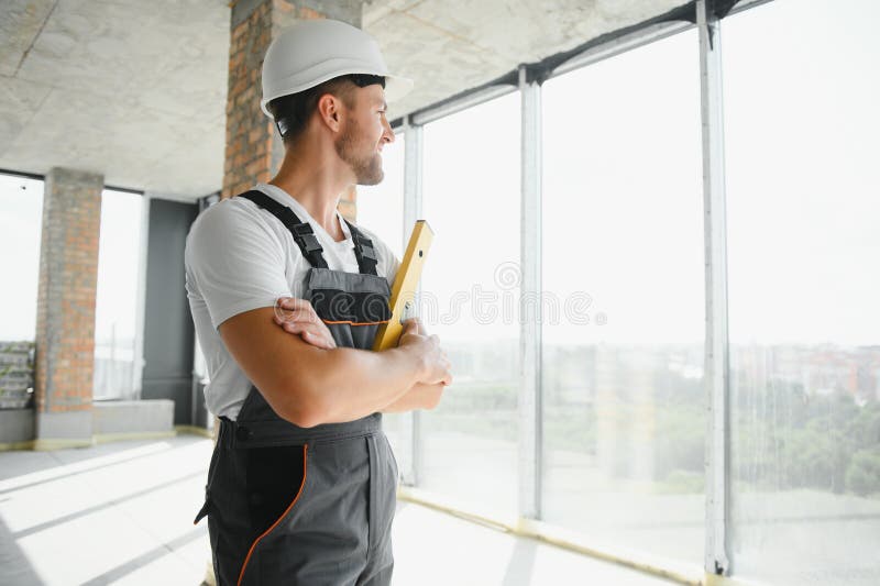 Man Builder Working in Construction Site. Male Repairer in Overall and ...