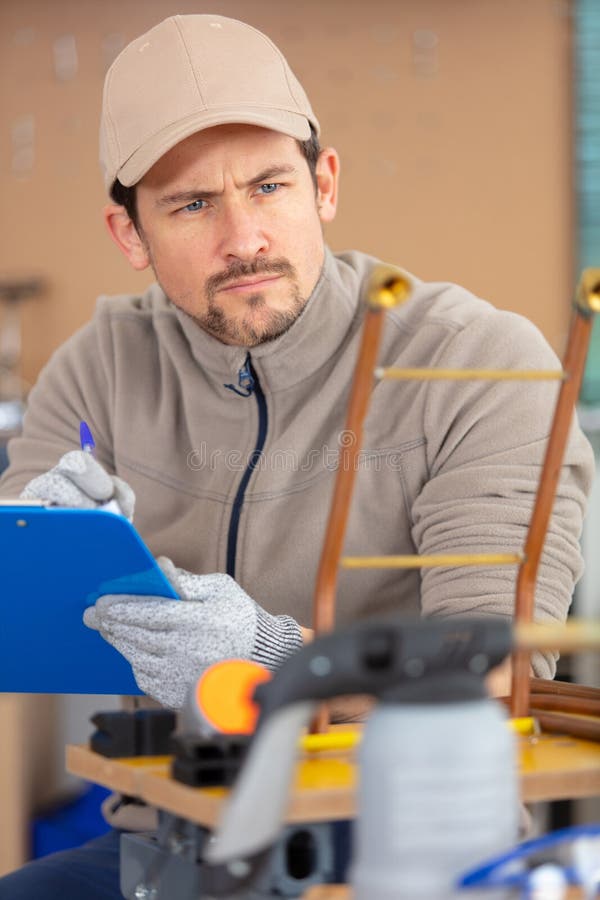 Man Builder Writing on Clipboard Inspecting Construction Site Stock ...
