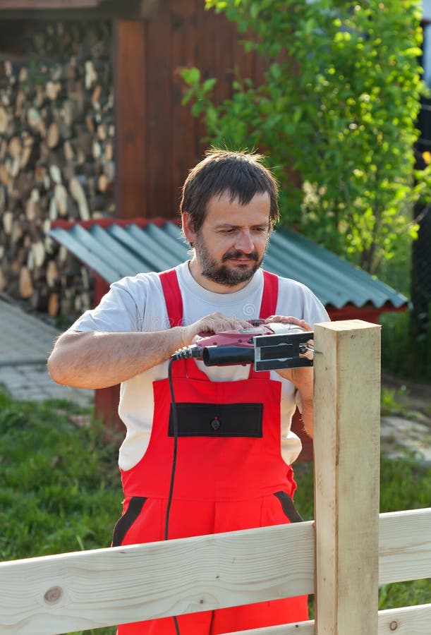 Man building a fence stock photo. Image of manual, fence - 67848584