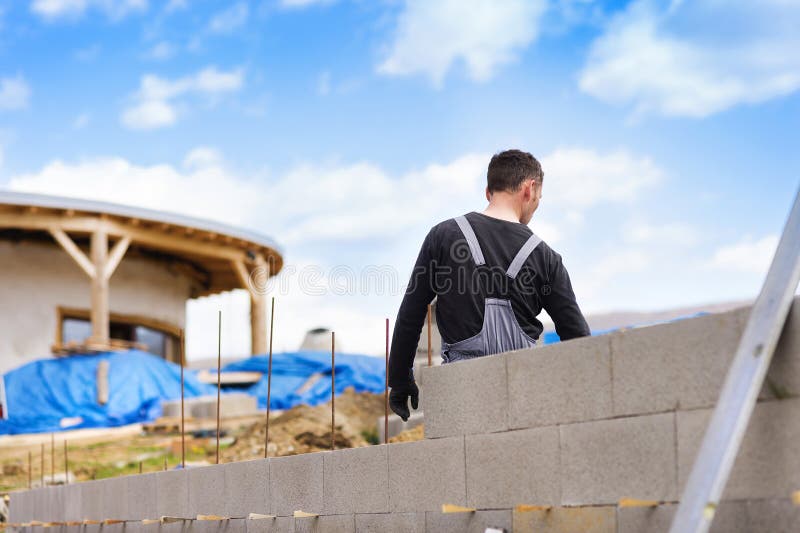 Man building a house stock image. Image of cement, house - 53956451